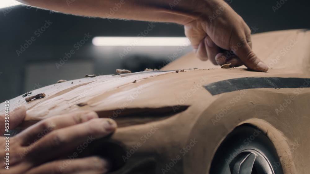 Close-up shot of male automotive designer working on eco friendly car ...