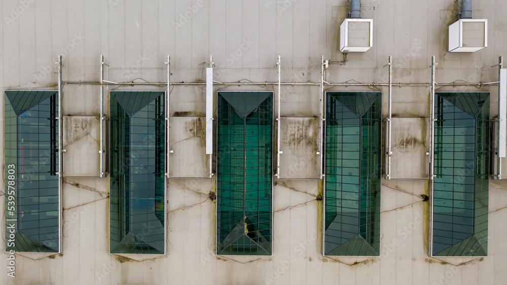 Top down view of modern triangular shape roof top skylight windows with ...