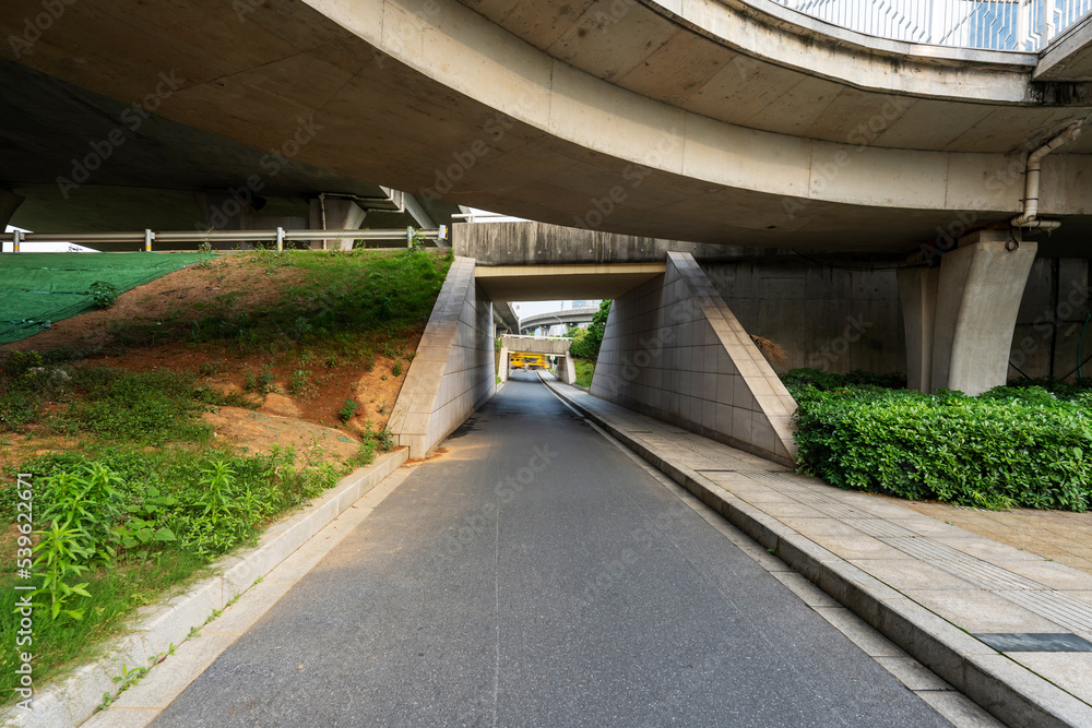 Concrete structure and asphalt road space under the overpass in the ...