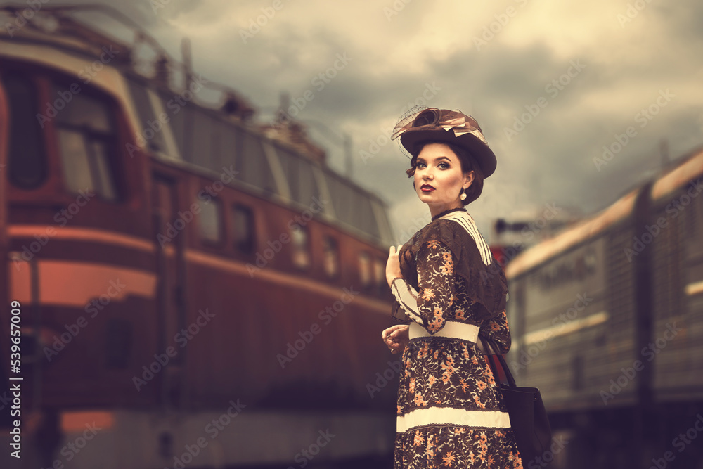 Beautiful girl in a historical retro dress on a background of an old ...