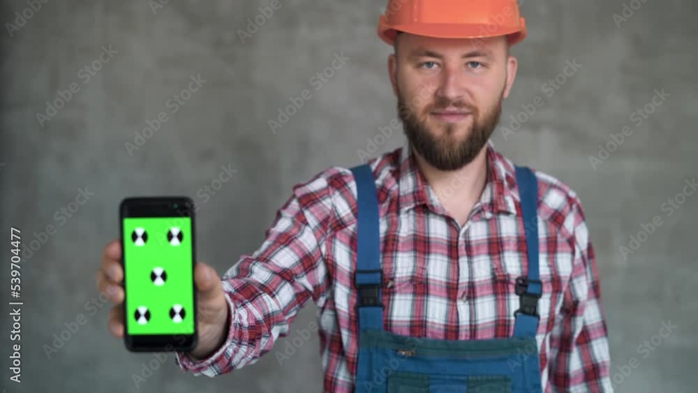 Building services. Male construction worker demonstrating blank ...
