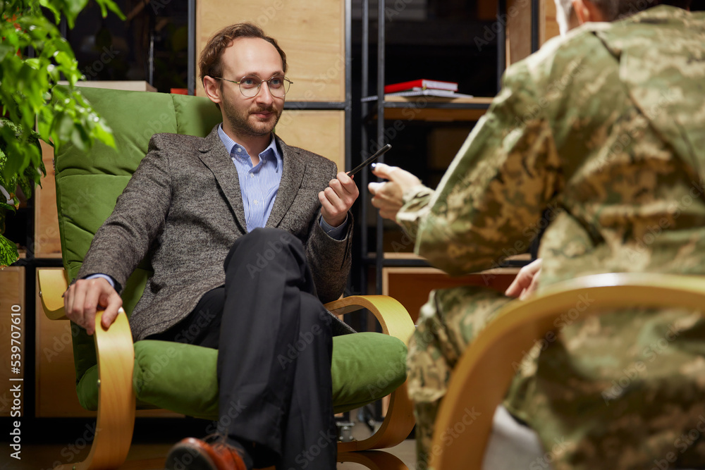 Military person having therapy session. Psychologist consults female ...