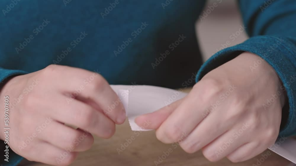 close-up female hands pull out paper envelope utility bill paper letter ...