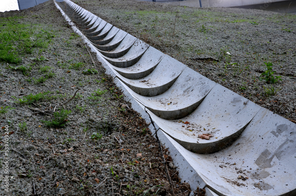 freeway bridge drainage. A sound-absorbing wall with holes lets water ...