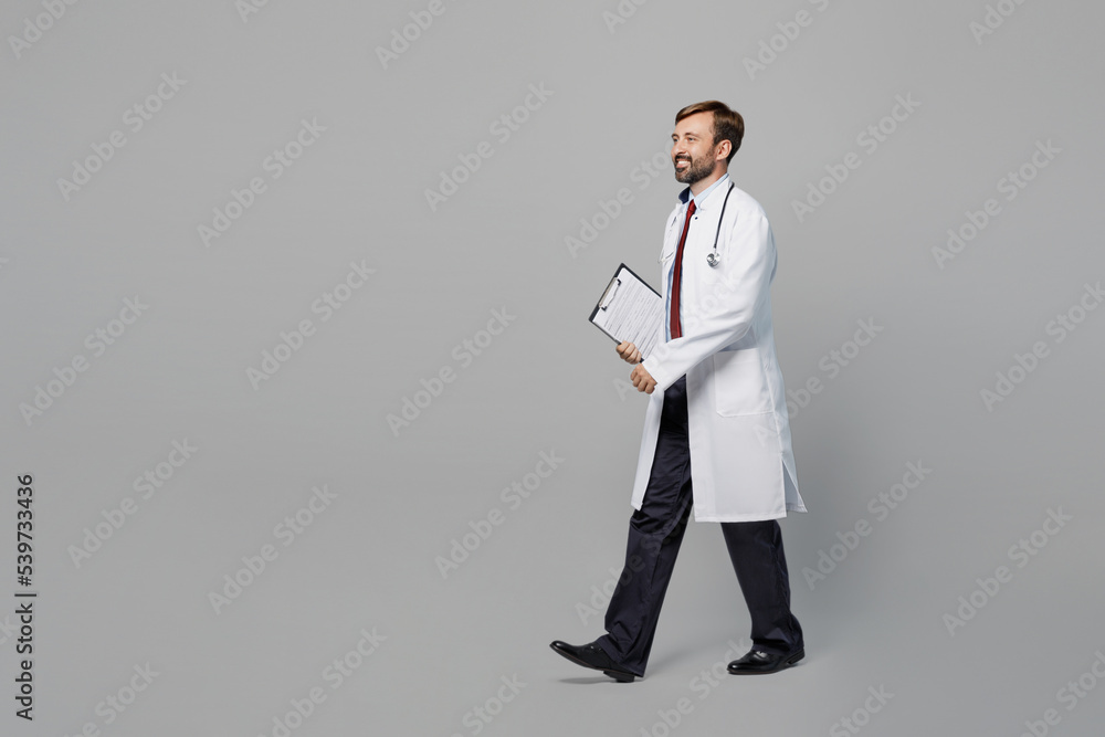 Full body side view male doctor man wears white medical gown suit work ...