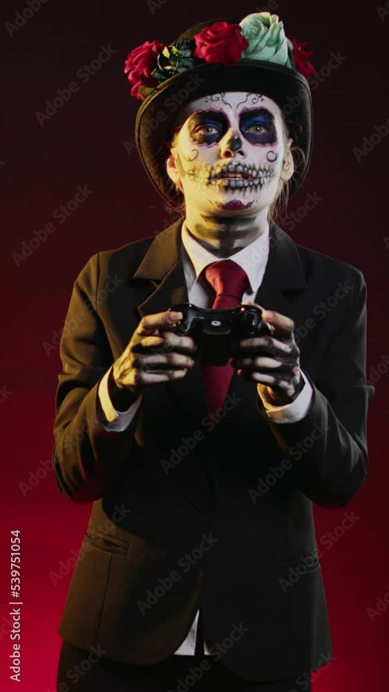 Vertical video: Woman with lady of death body art playing video games ...