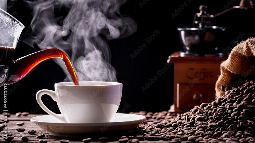 Coffee being poured into a cup up close, on a black background, with ...