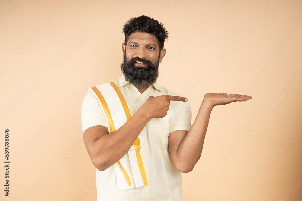 Excited South Indian man pointing finger for advertisement isolated on ...