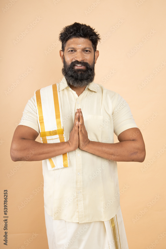 Happy South indian man in a greeting pose to Namaste hands isolated on ...