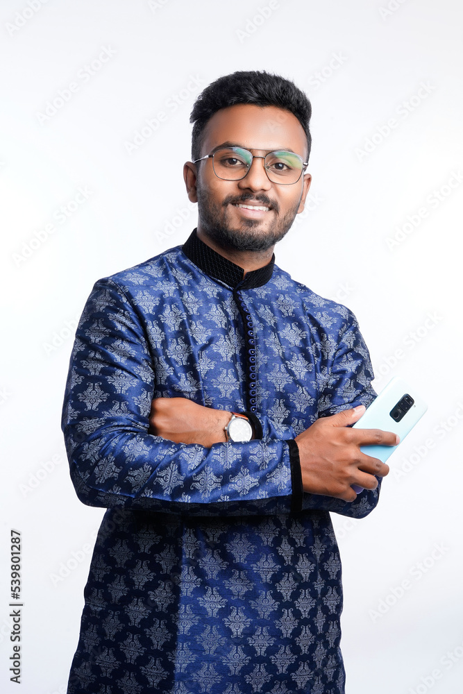 Happy handsome indian man wearing traditional outfit holding or using ...
