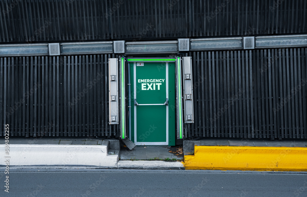 Emergency exit sign in an underpass highway tunnel road. Transportation ...