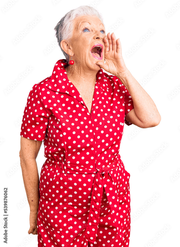 Senior beautiful woman with blue eyes and grey hair wearing a red ...