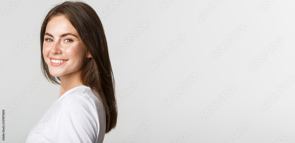 Portrait of confident beautiful brunette woman turning face at camera ...