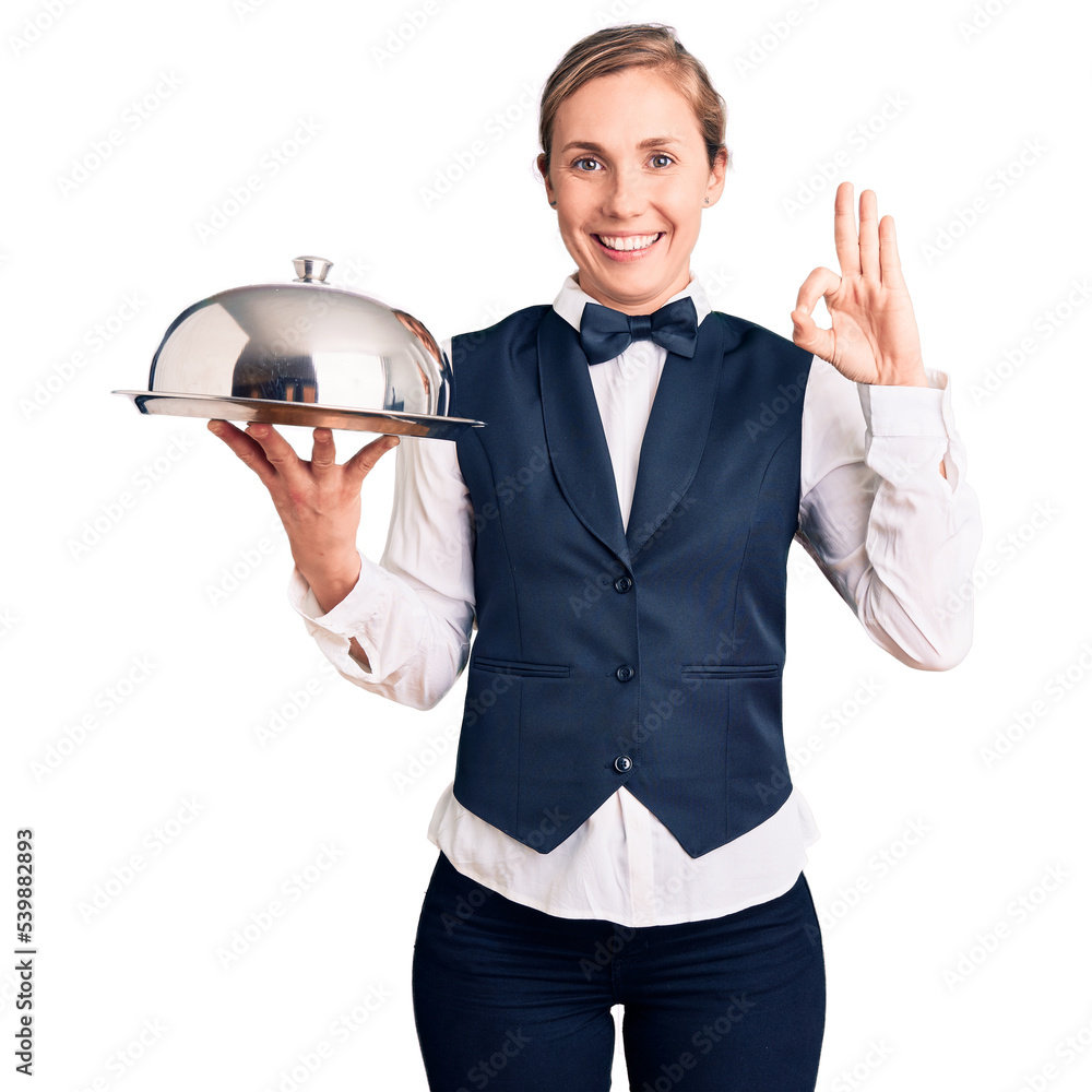 Young beautiful blonde woman wearing waitress uniform holding tray ...