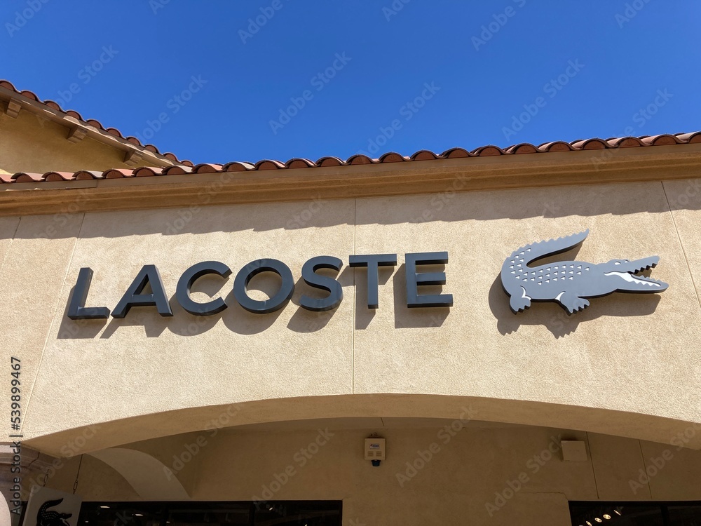 Lacoste sign, logo on the store facade at Desert Hills Premium Outlets ...