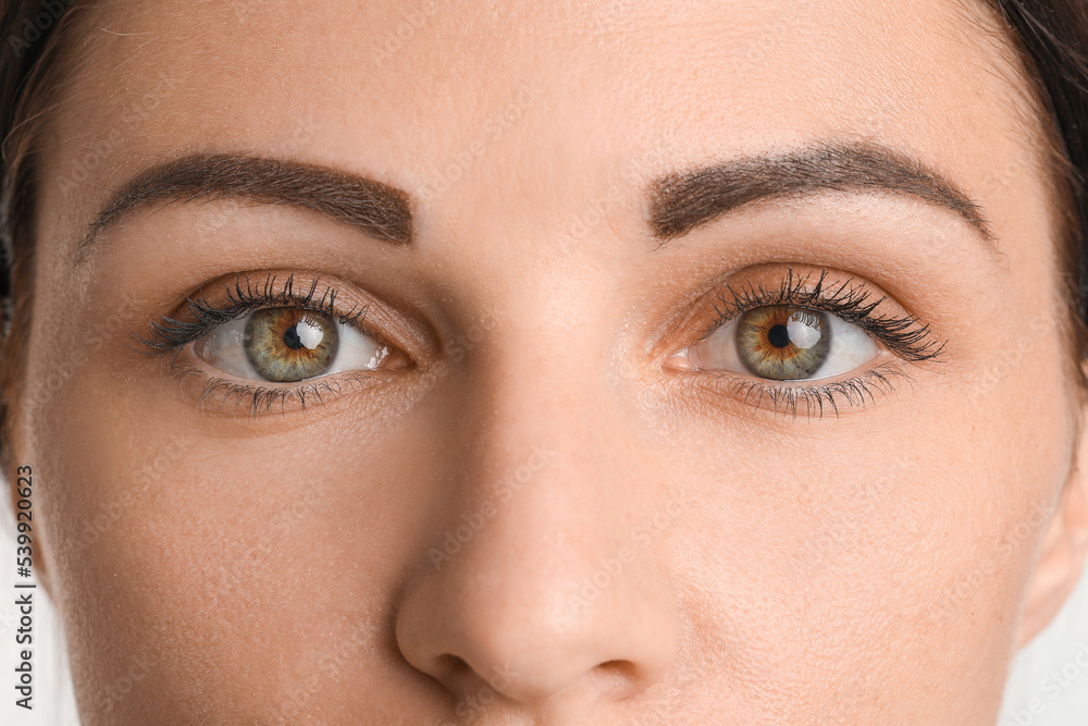 Young woman with beautiful hazel eyes on white background, closeup ...