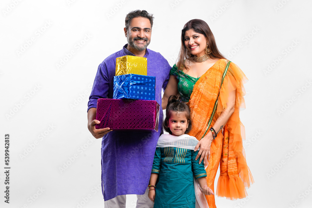 Indian family celebrating Diwali / Deepavali in traditional wear while ...
