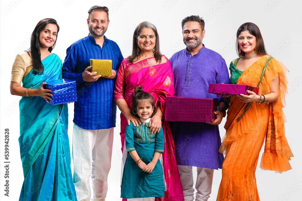 Happy indian family in traditional wear and standing on white ...