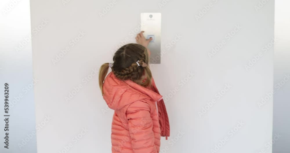 Cute little girl pressing elevator button with her finger. Child ...
