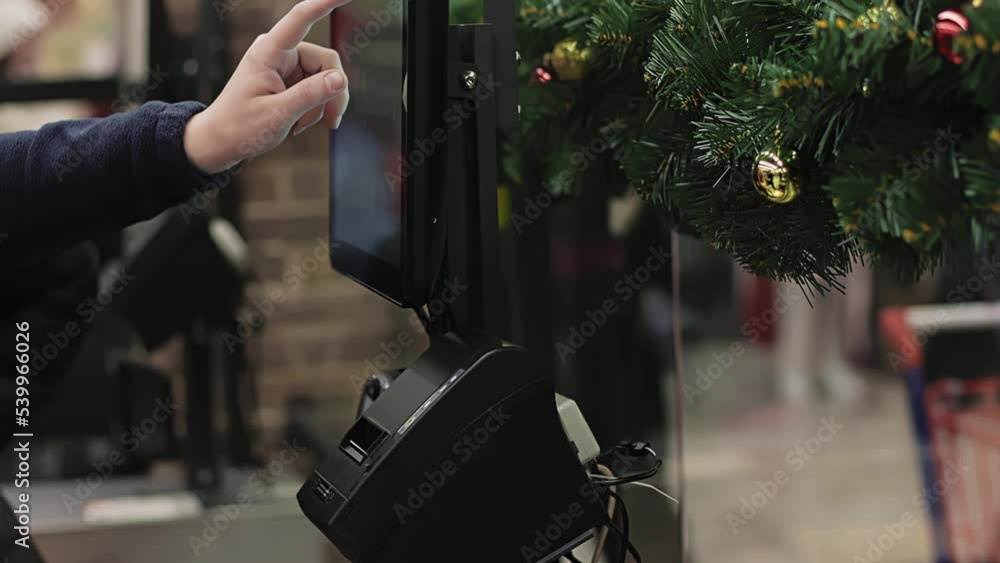 Buyer uses touch panel at self-service checkout ACO. Customer manually ...