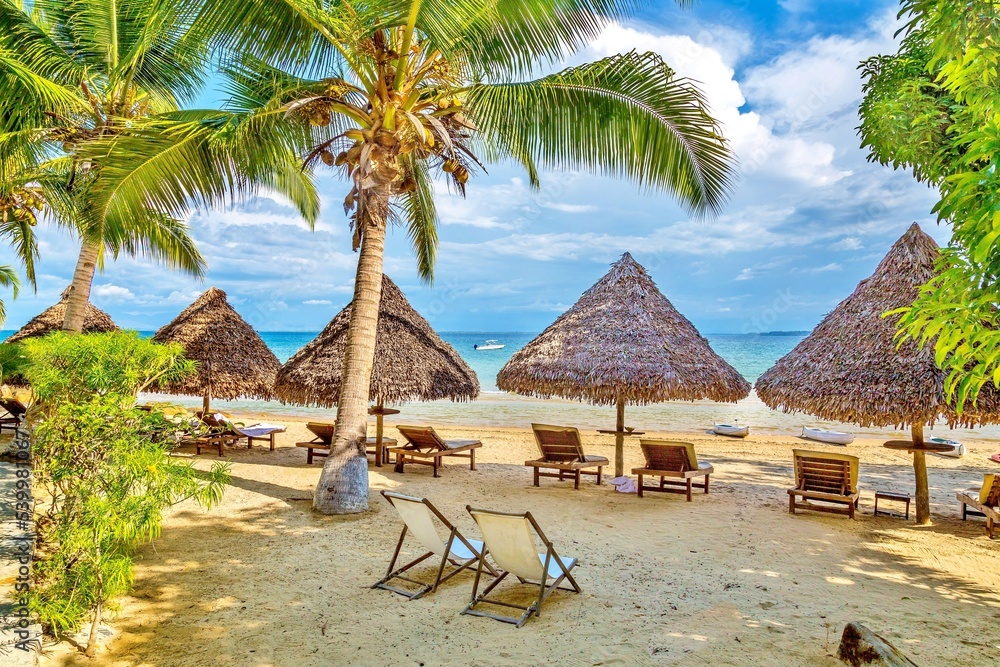 Beach umbrellas and deck chairs by the sea at Nosy Be island, Nosy ...