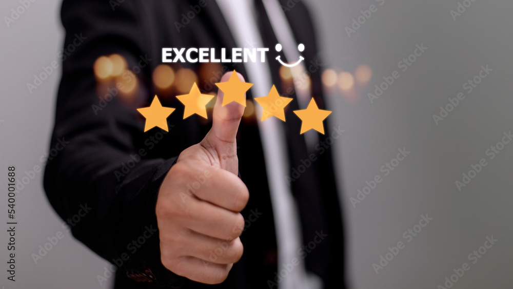 Foto de customer hand with gold five star rating feedback icon and ...