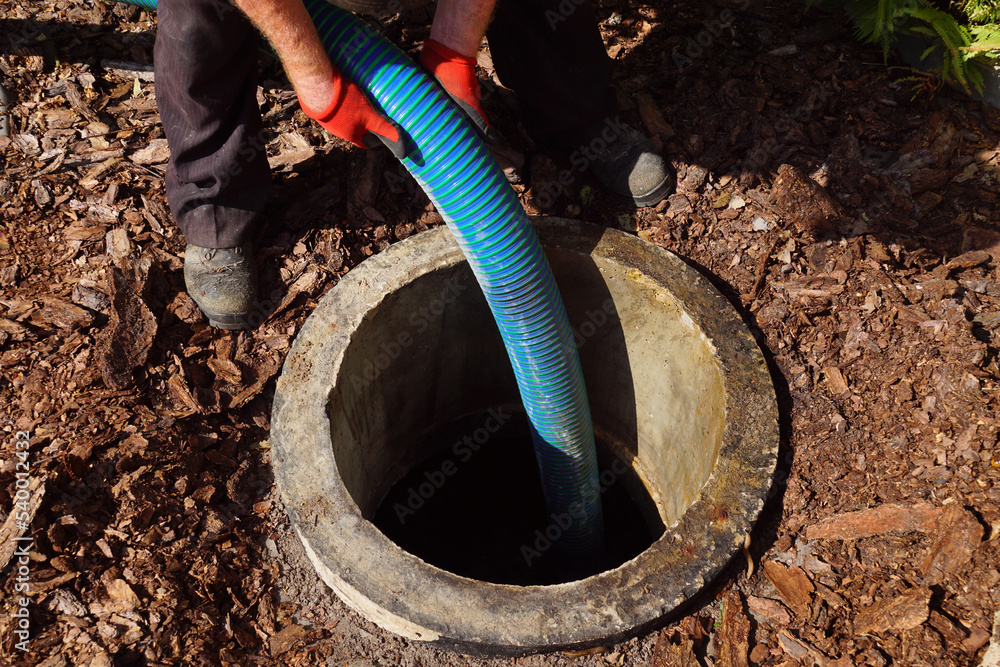 Pumping out sewage from a septic tank. Pipe in the drainage pit. Stock ...