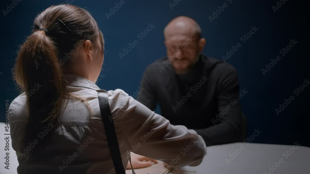 Female FBI agent interrogates suspected criminal in handcuffs. Police ...