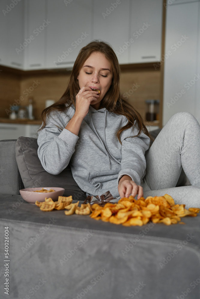 Caucasian woman with bulimic eating unhealthy food at home Stock Photo ...