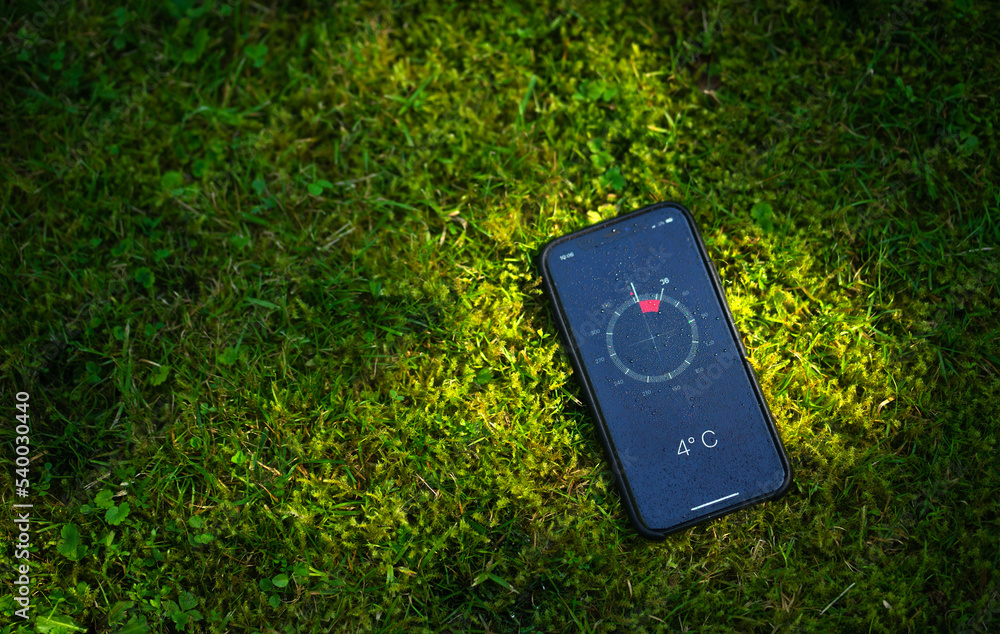 The smartphone is lying on the grass with the compass turned on ...