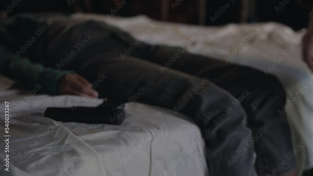 4k Young woman is taking gun and sitting on bed in retro room spbd ...