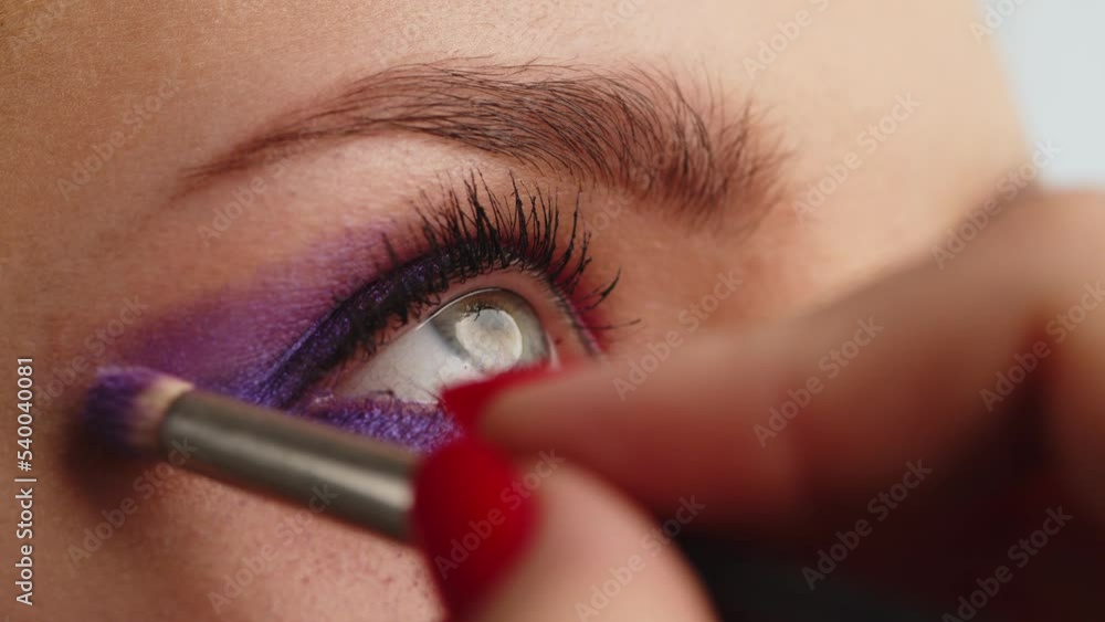 Make-up artist applies makeup to the upper eyelid, close-up. Makeup ...