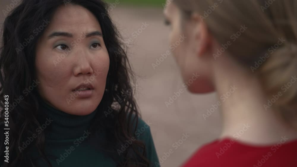 4k Closeup view of two women are looking at each other and standing on ...