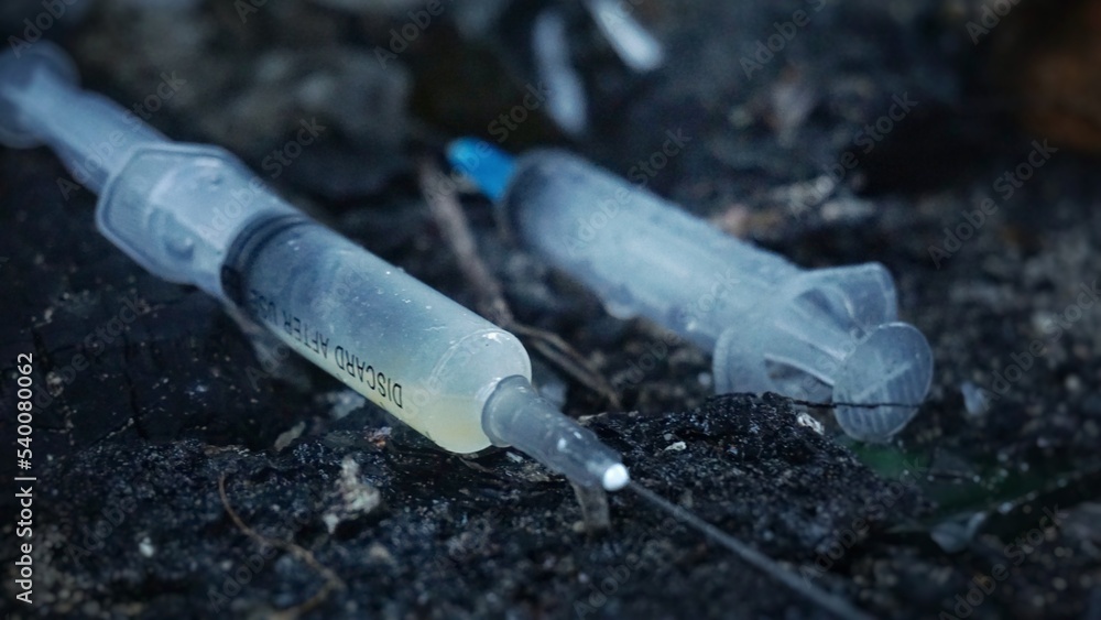 Syringes lie in an abandoned house, at a construction site, in ruins ...