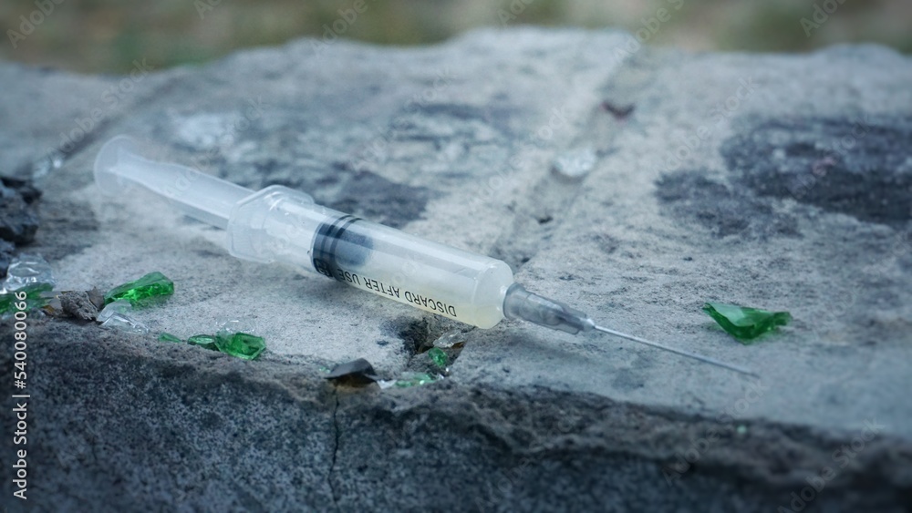 Syringes lie in an abandoned house, at a construction site, in ruins ...