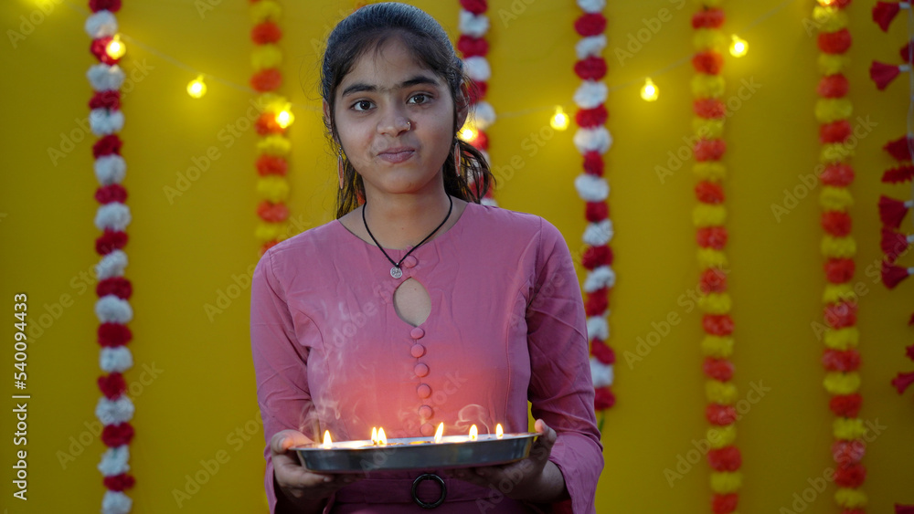 Diwali Hindu Festival of lights celebration. Diya or oil lamp in woman ...