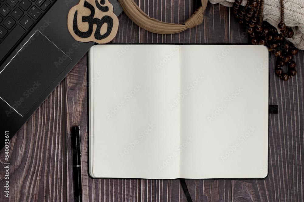 Mockup with notebook, pen, ohm symbol, knitting coat, wooden beads and ...