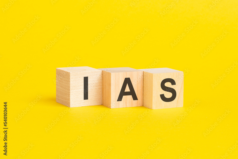 ias text on wooden toy blocks, financial business concept, yellow ...