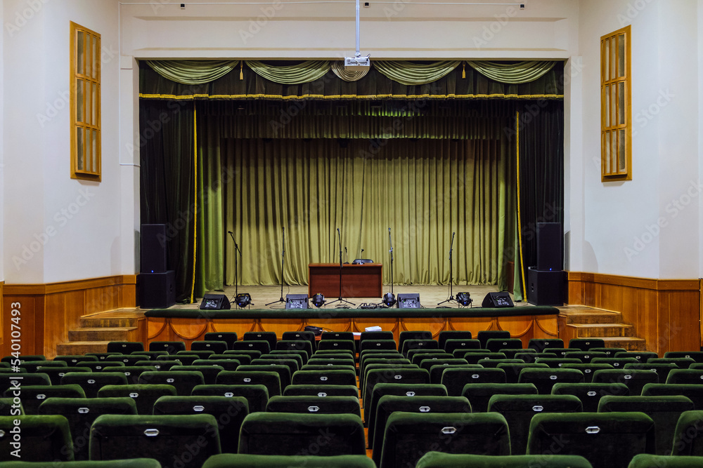Assembly hall with stage for performance and rows of empty chairs Stock ...