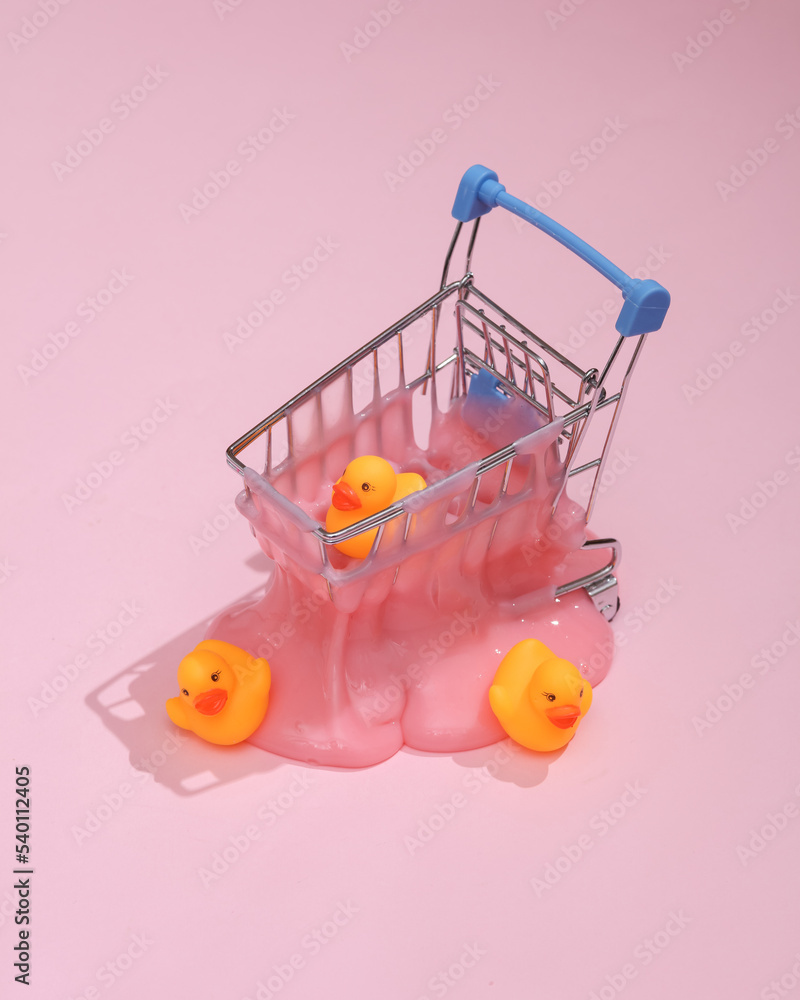 Creative summer layout, mini shopping trolley with slime and rubber ...