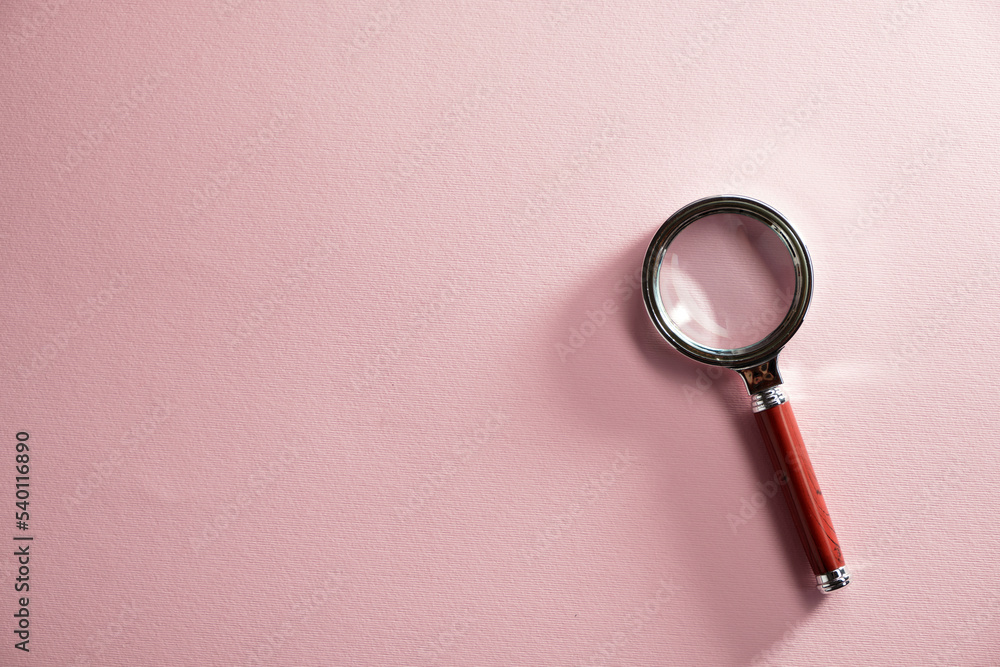 magnifying glass against pink background Stock Photo | Adobe Stock