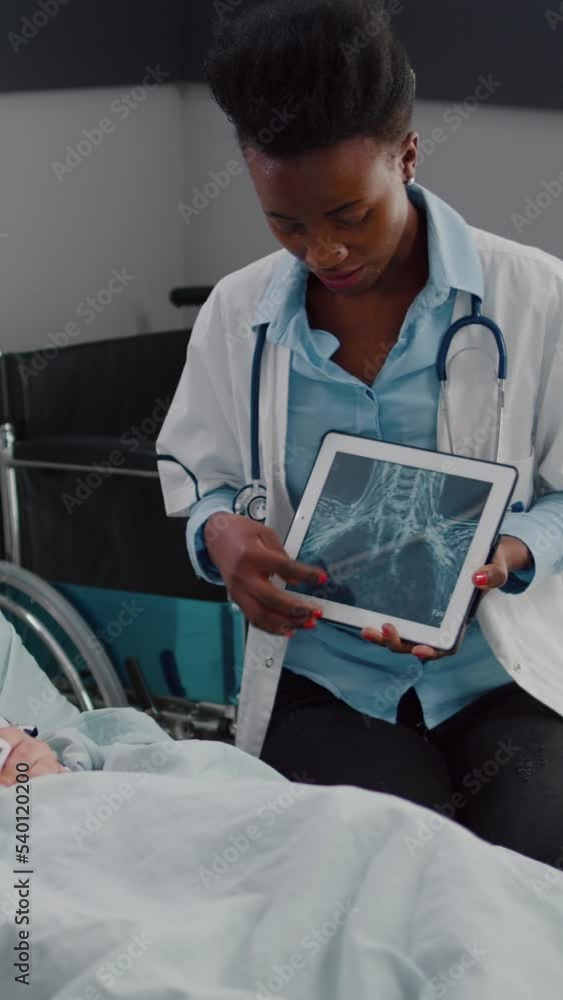 Vertical video: Specialist surgeon black woman doctor explaining ...