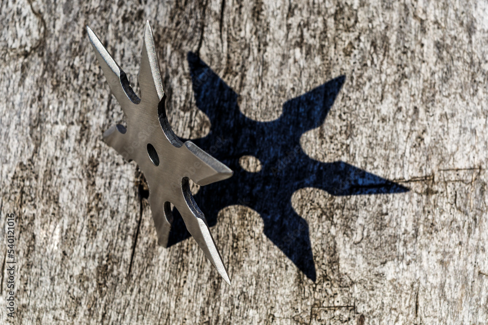 Shuriken (throwing star), traditional japanese ninja cold weapon stuck ...
