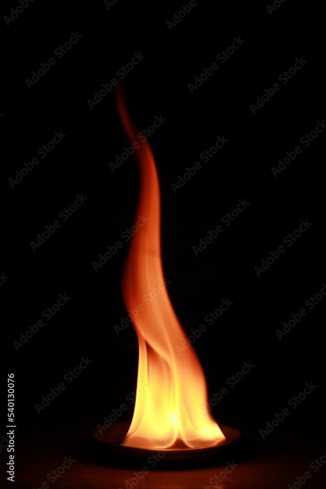 Vertical closeup illustration of a camphor flame on the dark background ...