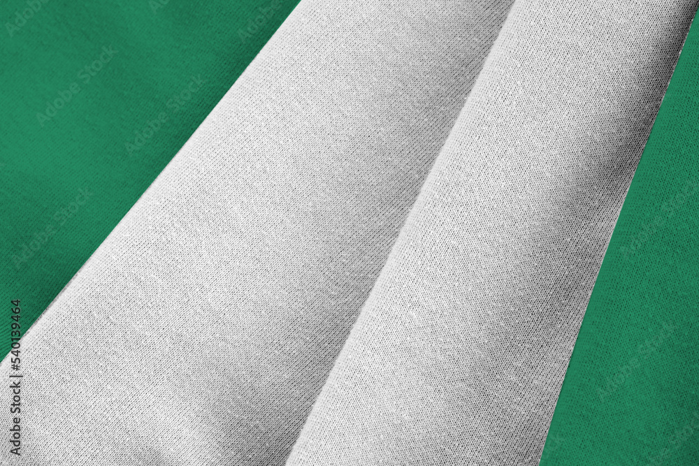 Nigeria flag with big folds waving close up under the studio light ...