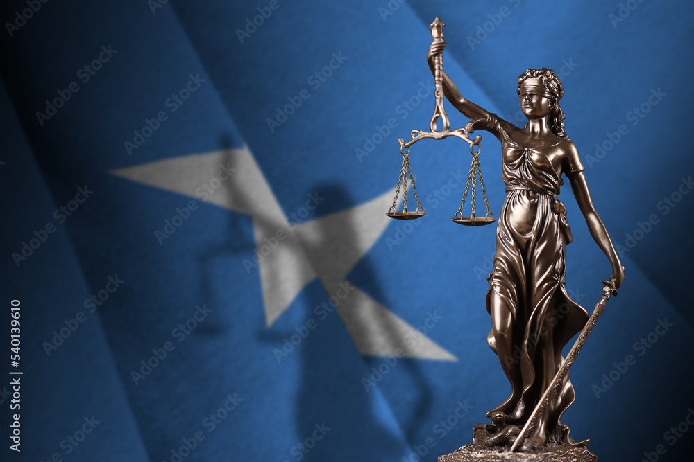 Somalia flag with statue of lady justice and judicial scales in dark ...