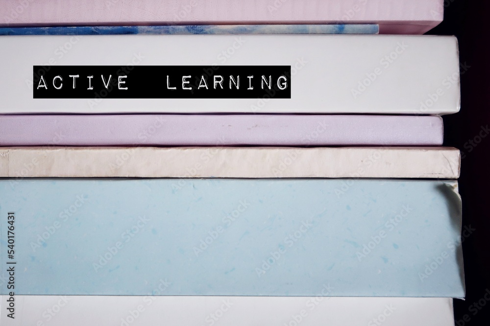 Text books on shelve with text on spine written ACTIVE LEARNING, means ...