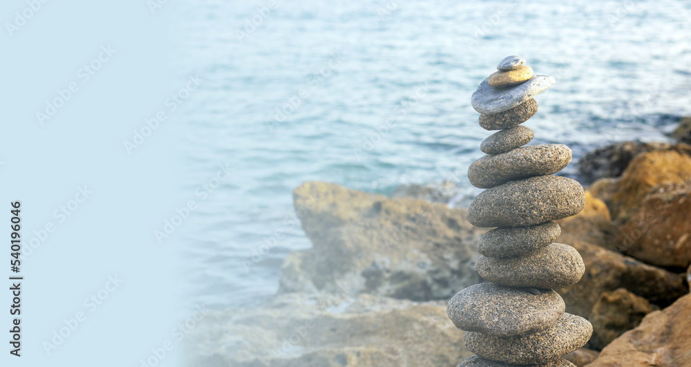 pebbles sea stone in pyramid one over another on seashore coast line ...