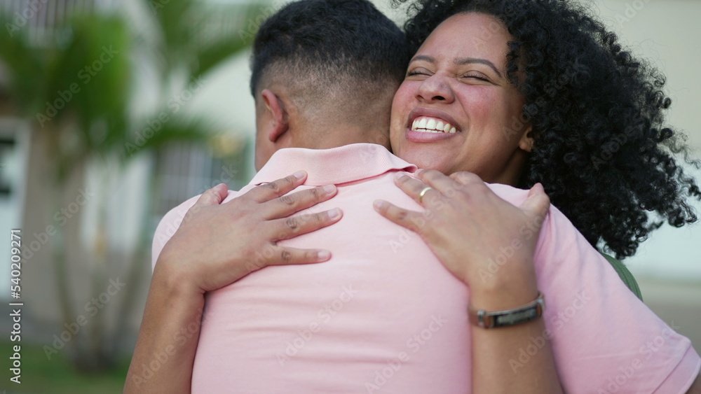 Young woman embracing male friend. Authentic real life reunion ...