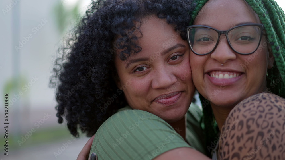 Two black sisters showing love and affection. African American sibling ...